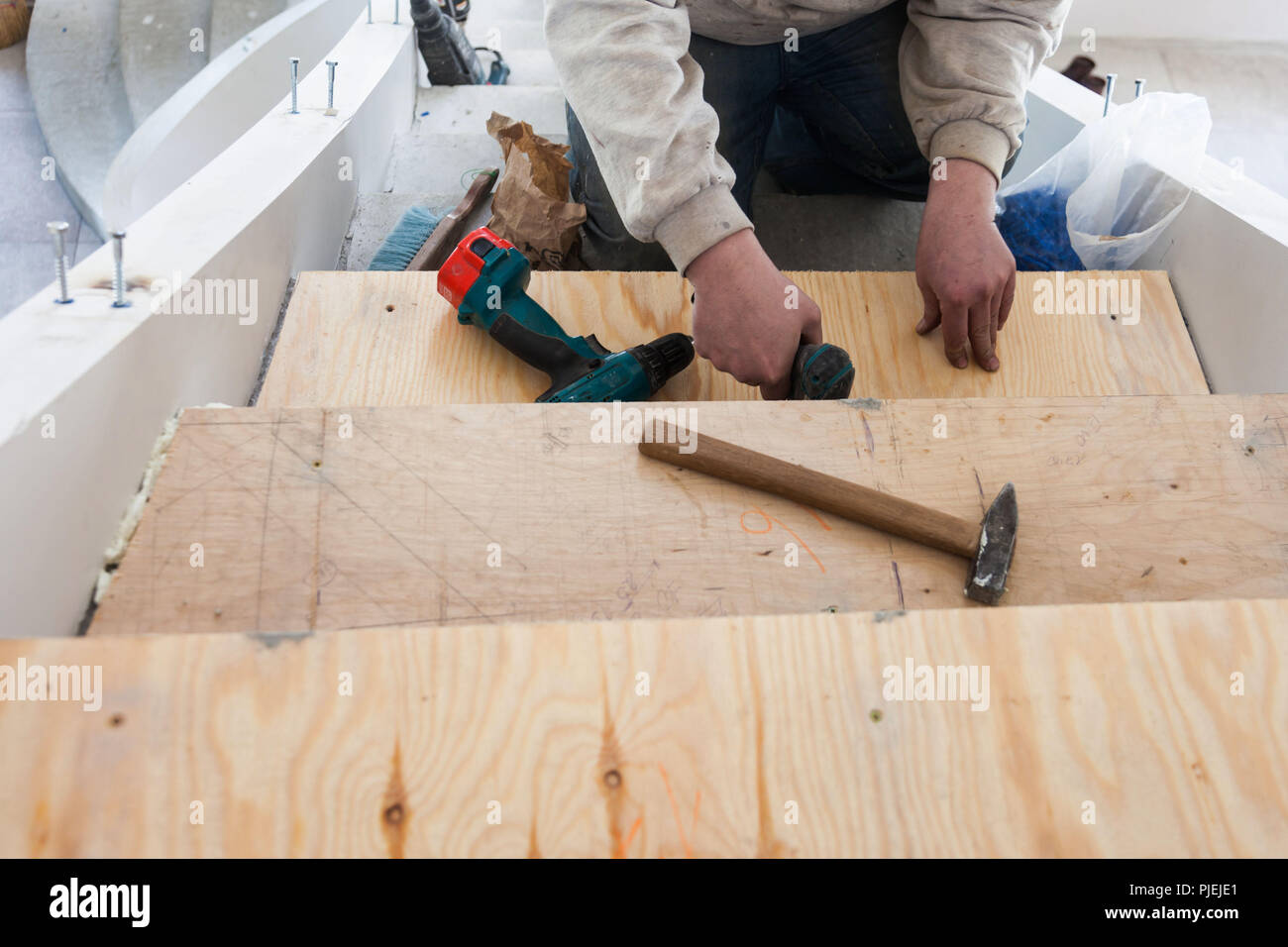 Production and installation of flax. Work of the master Stock Photo - Alamy