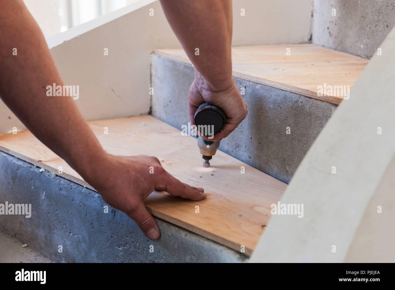 Production and installation of flax. Work of the master Stock Photo - Alamy