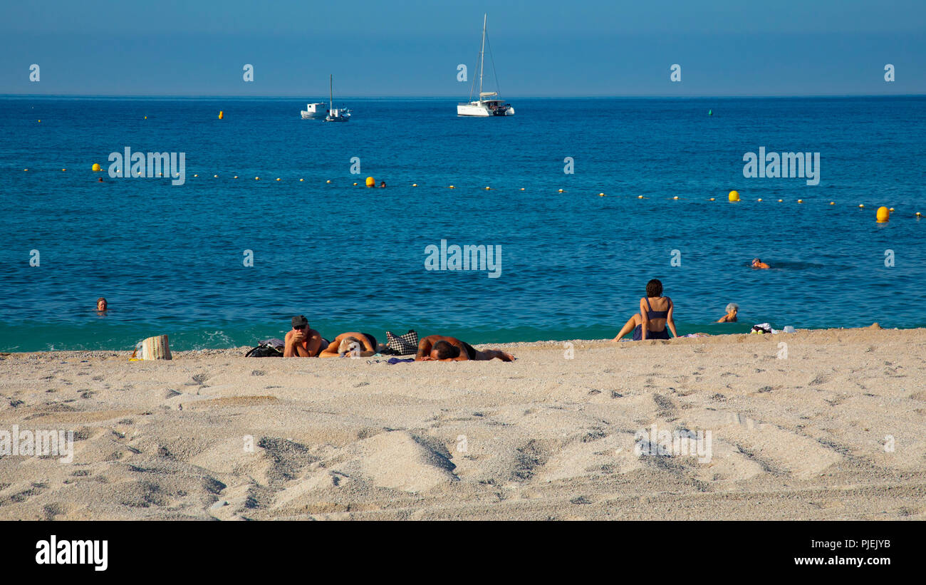Tourists tanning on beach in Cassis a Mediterranean fishing port in ...
