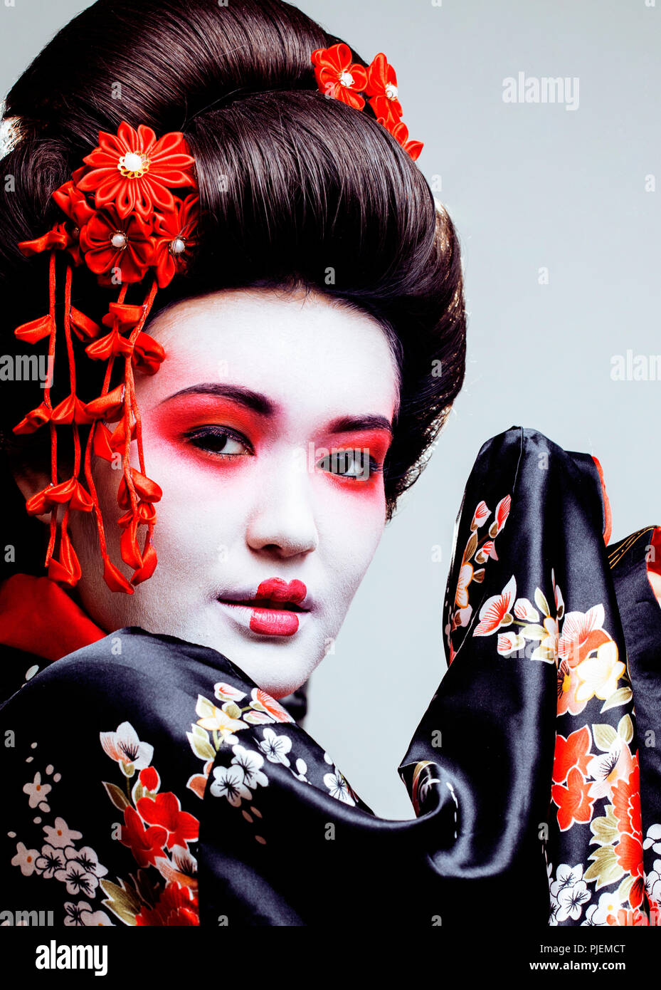 young pretty geisha in black kimono among sakura, asian ethno Stock ...