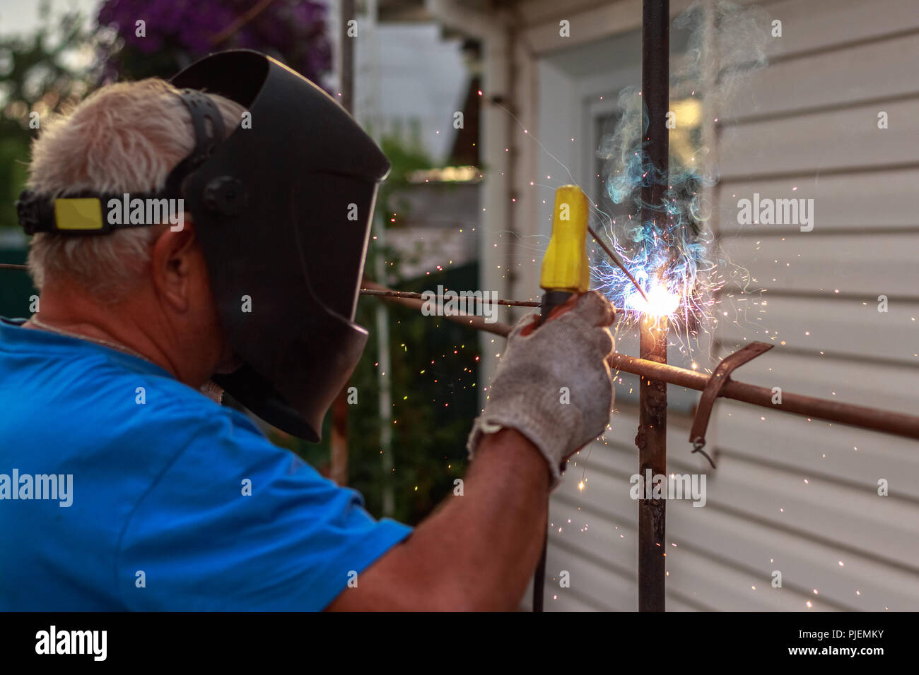 Worker summer worker works with welding on site Stock Photo - Alamy