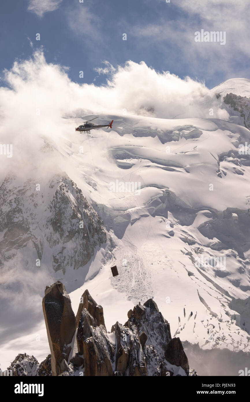 Rescue helicopter flying through the Alps Stock Photo - Alamy