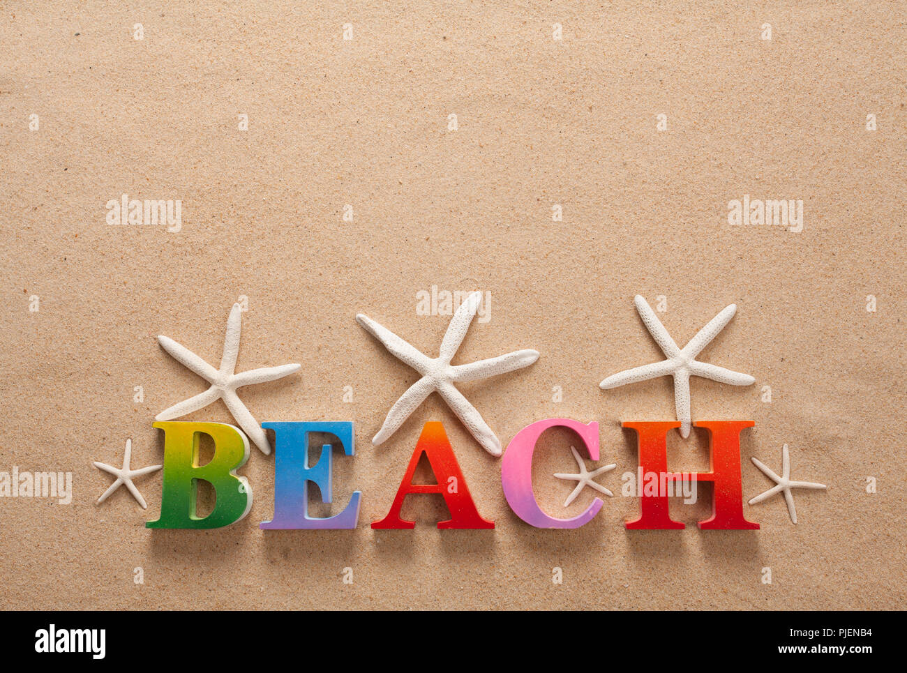 top view of beach written in colorful letters decorate with shellfish ...