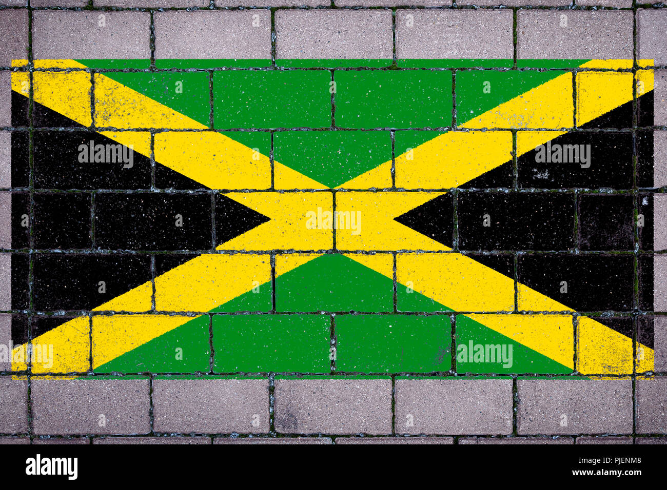 National flag of Jamaica against a background of a stone background ...