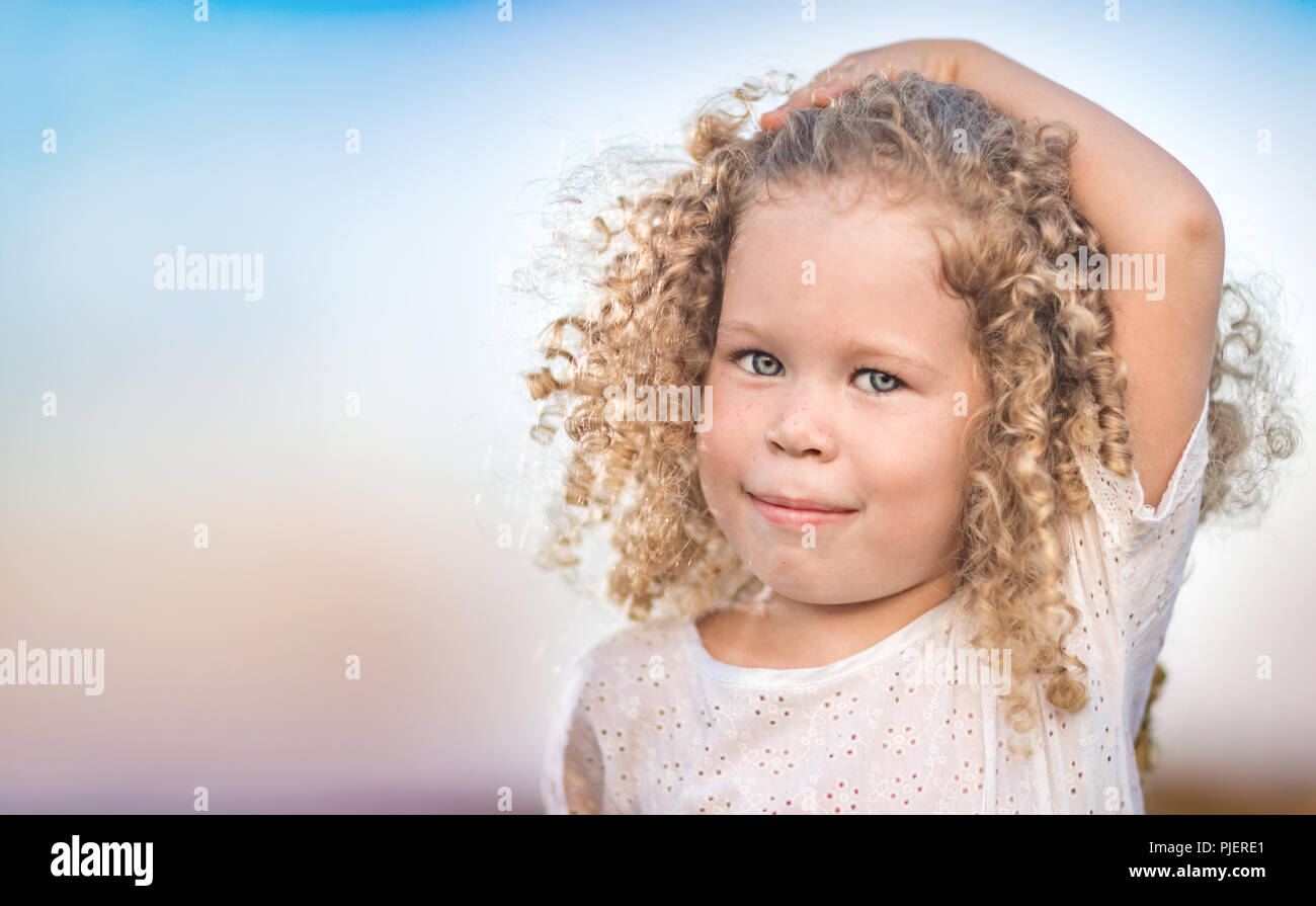 Outdoor portrait of a smiling little girl. Positive emotion concept ...