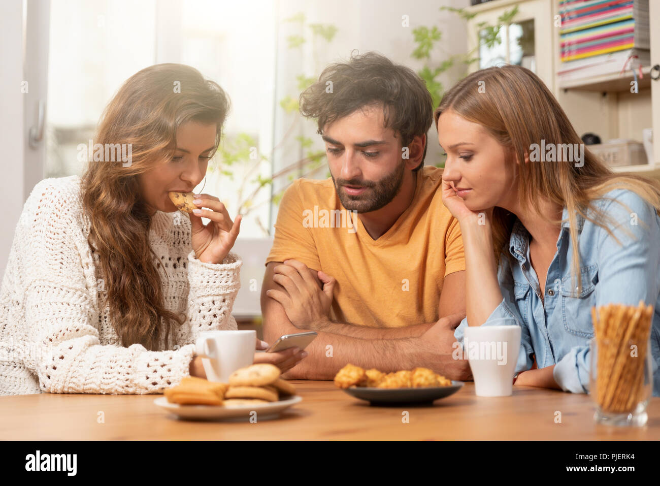 Group of friends watching content on smartphone. Friends spends free ...