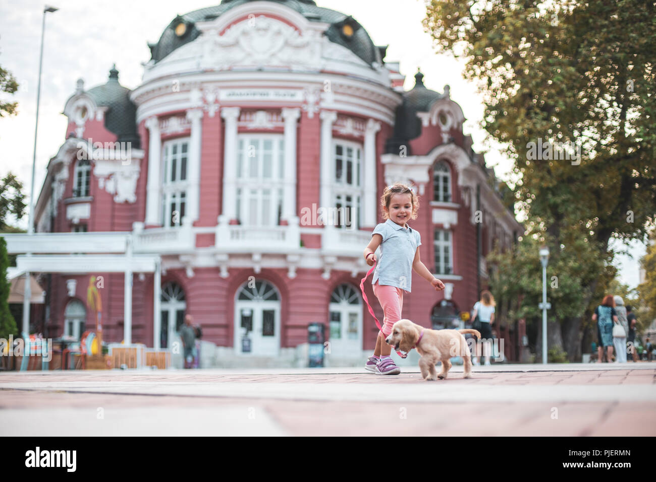 Little kid walking her cocker spaniel, dog in town Stock Photo - Alamy