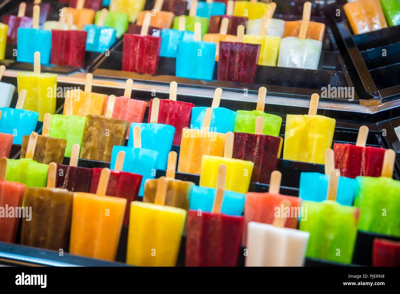 Delicious fresh colourful ice lolly on stick. Freshly made fruit ice ...