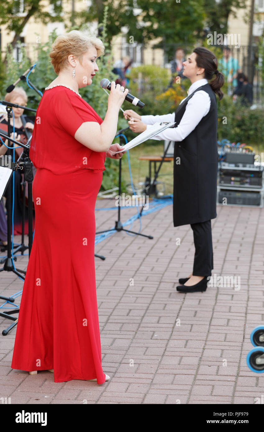 Opera singer at gala concert. Vitebsk symphonic orchestra at open-air ...