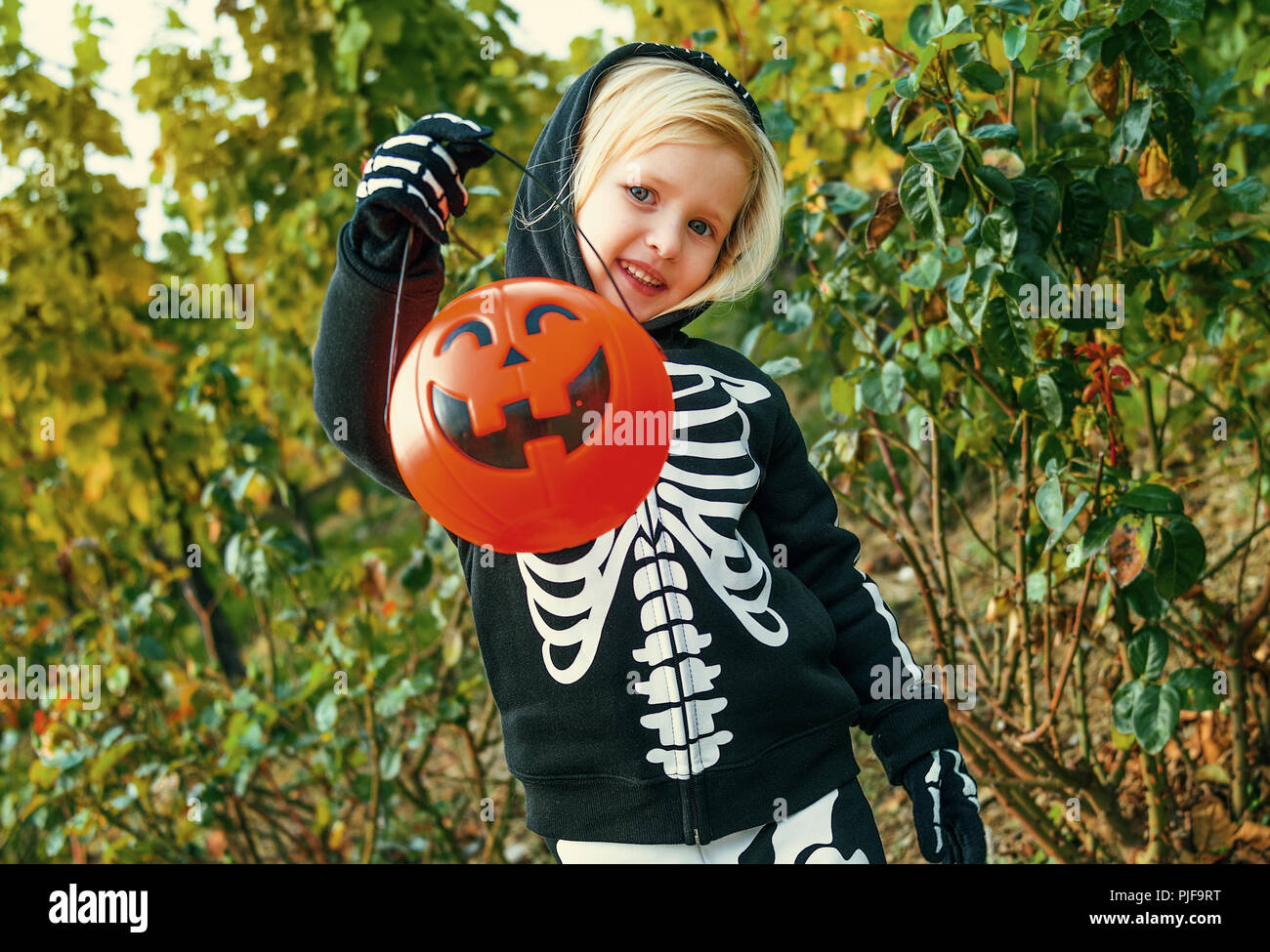 Trick or Treat. child wearing skeleton costume on Halloween outdoors ...