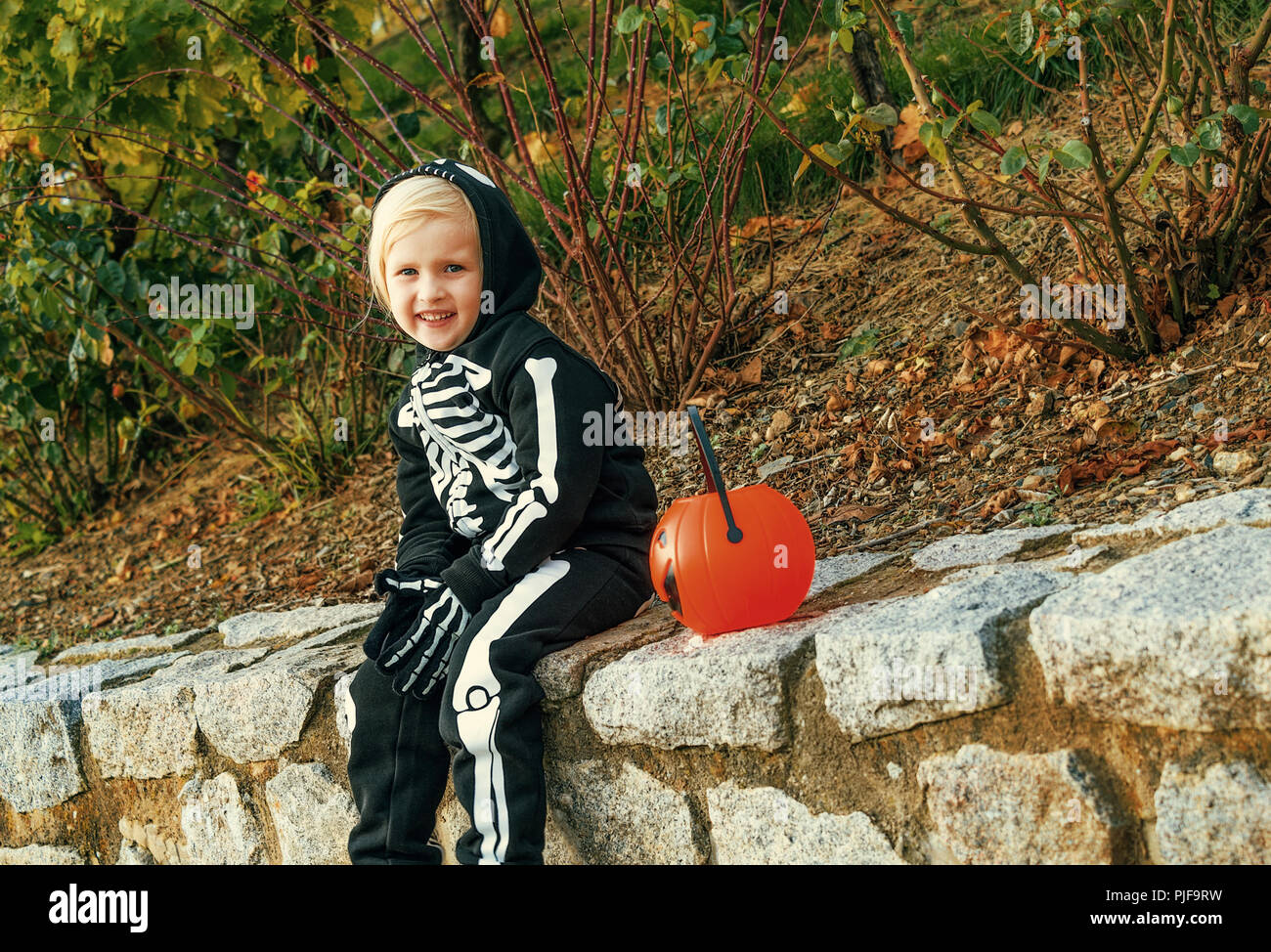 Trick or Treat. happy child wearing skeleton costume on Halloween ...