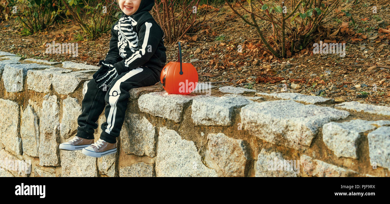Trick or Treat. happy child wearing skeleton costume on Halloween ...