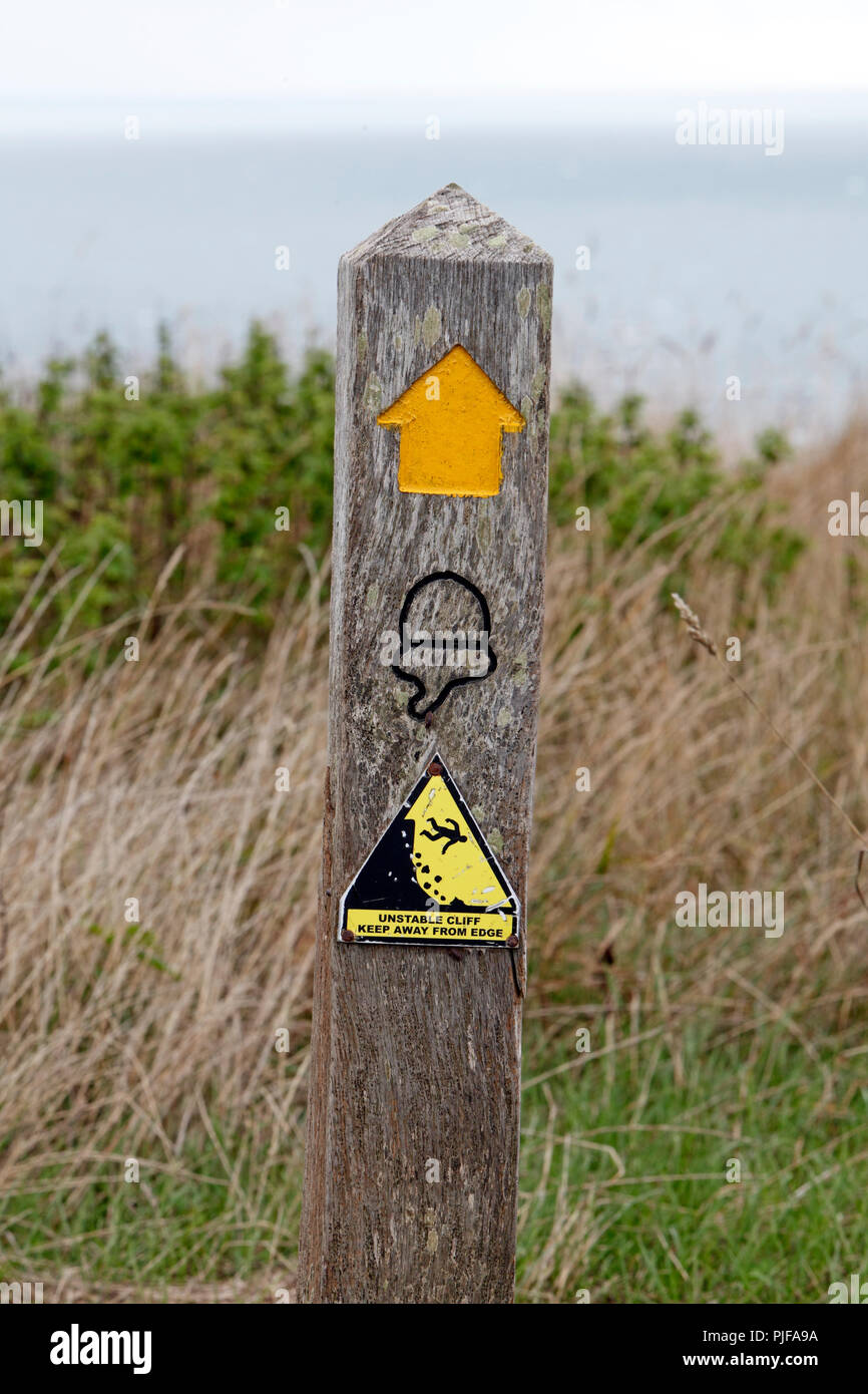 waymarker sign showing danger of cliff falls to walkers Stock Photo - Alamy