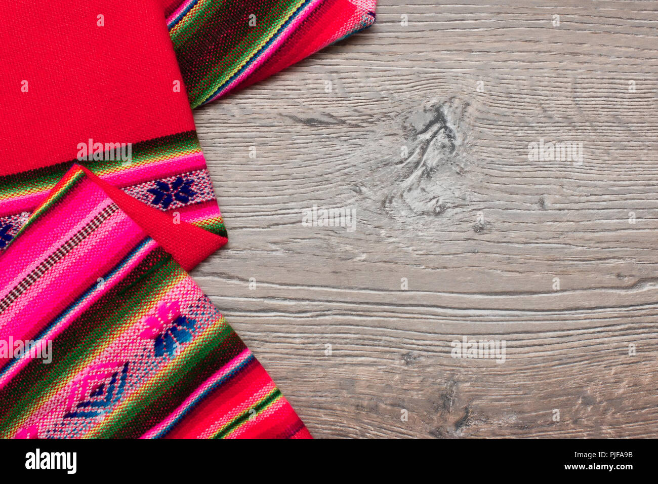 Natural background of thick multicolor patterned tablecloth on dark ...