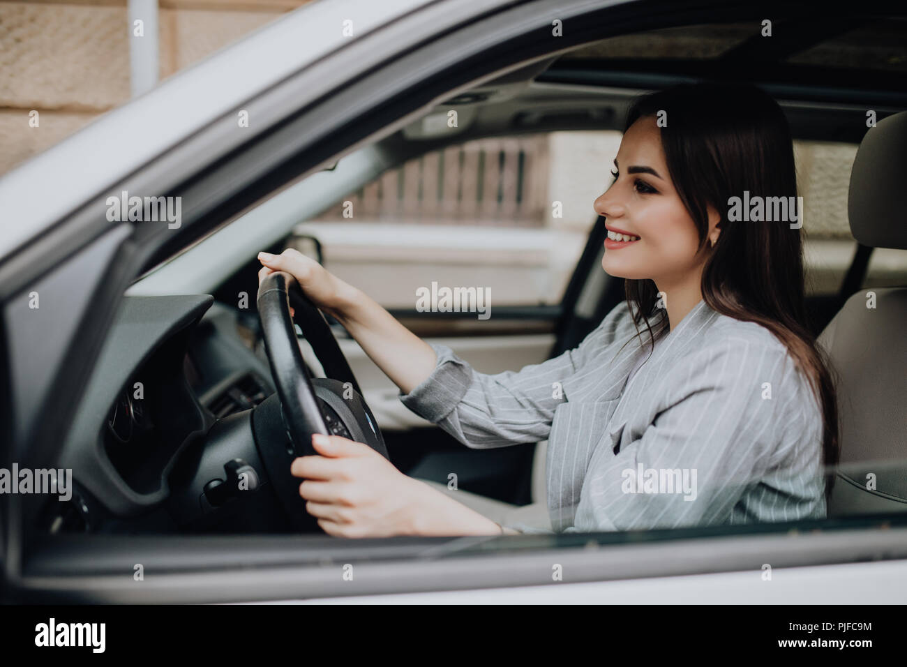 Beautiful Smiling woman driving car, attractive girl sitting in ...