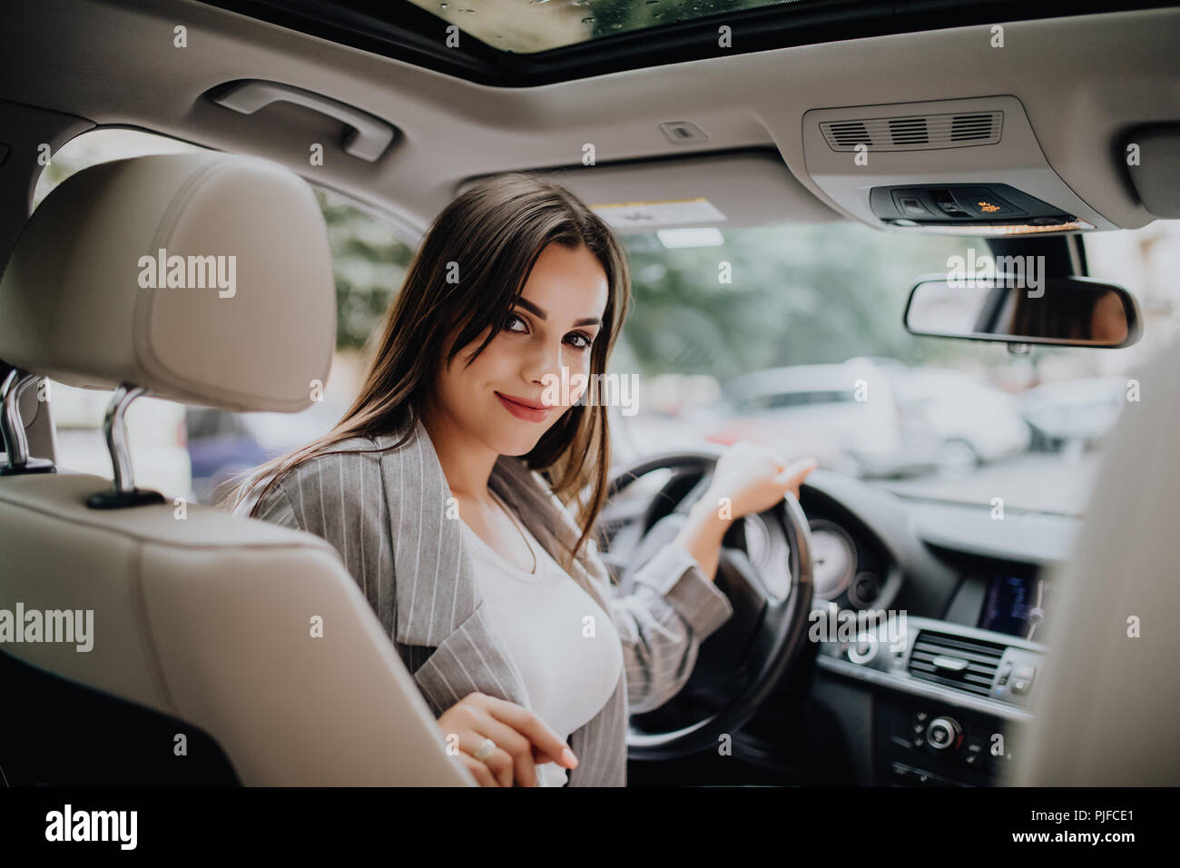 Back view of an attractive business woman looking over her shoulder ...