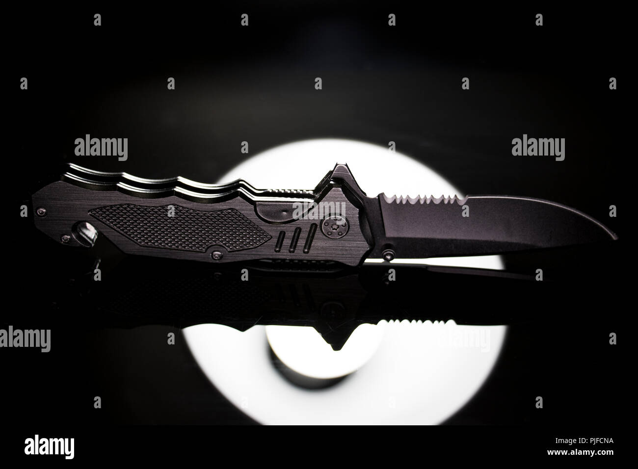Black Ops Knife with serrated black blade Stock Photo - Alamy