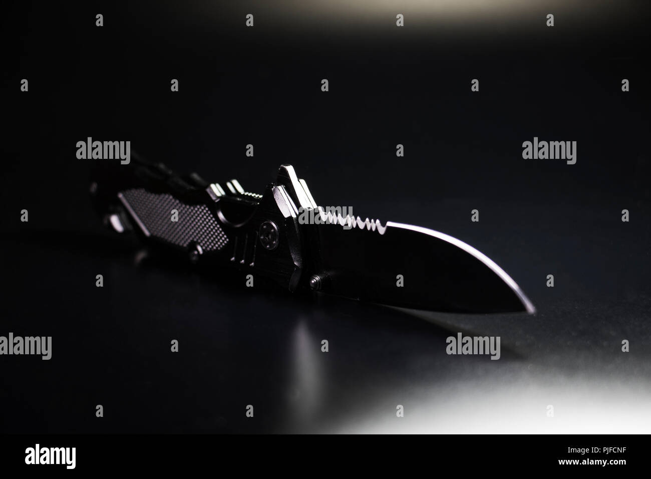 Tactical knife. Black knife spring assist spring loaded weapon ...