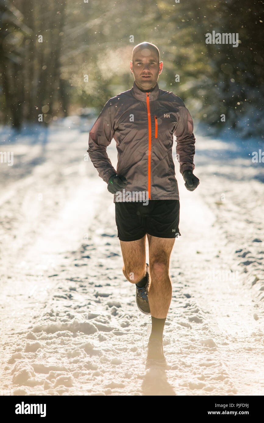 Healthy man running in a winter day Stock Photo - Alamy