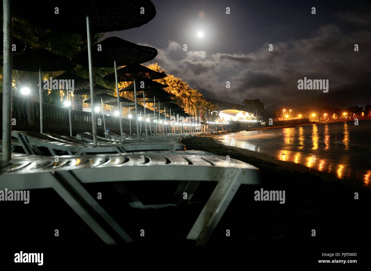 Holiday resort by night in Kusadasi, Turkey. Aegean Sea and beach in ...