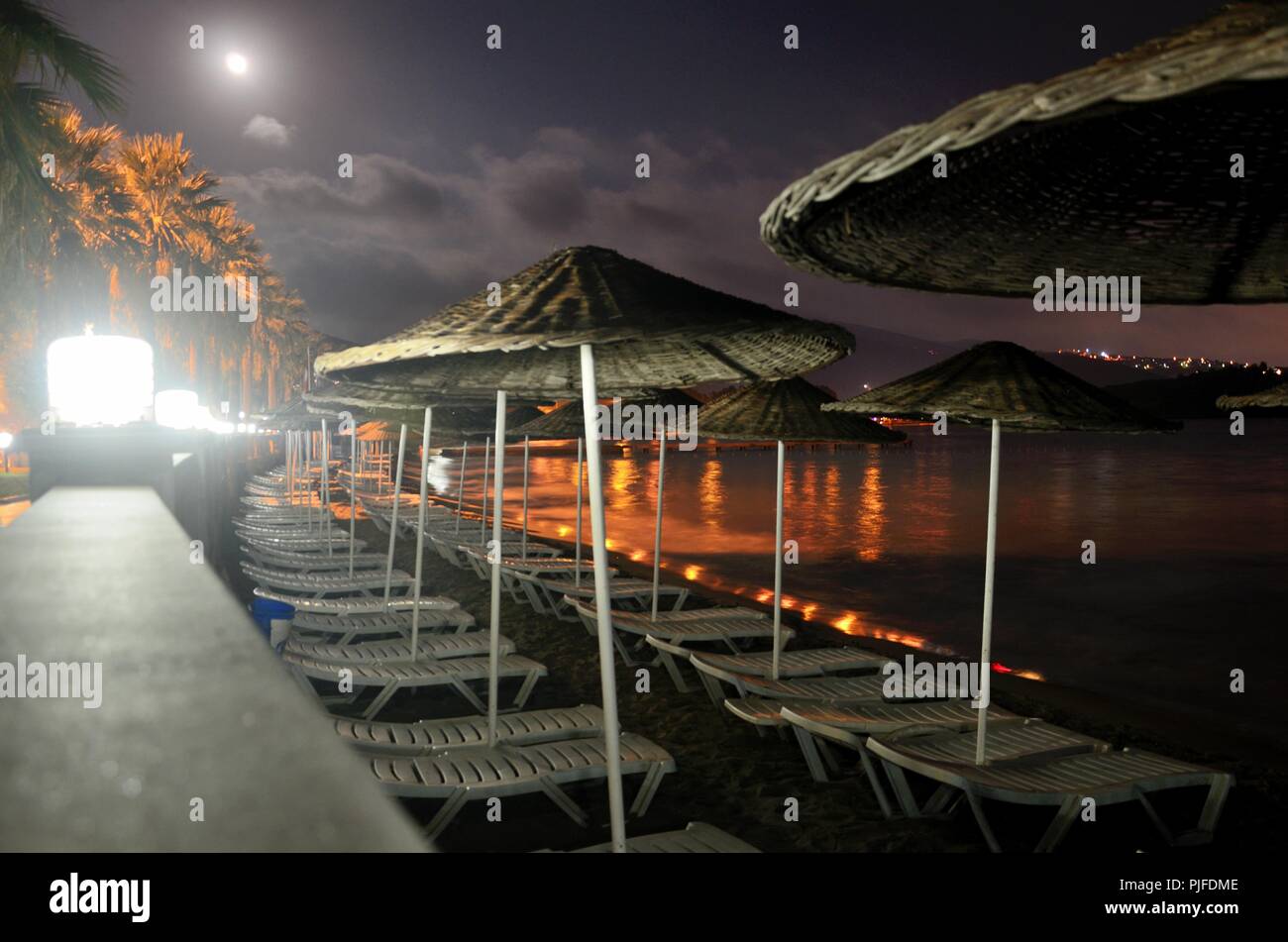 Holiday resort by night in Kusadasi, Turkey. Aegean Sea and beach in ...