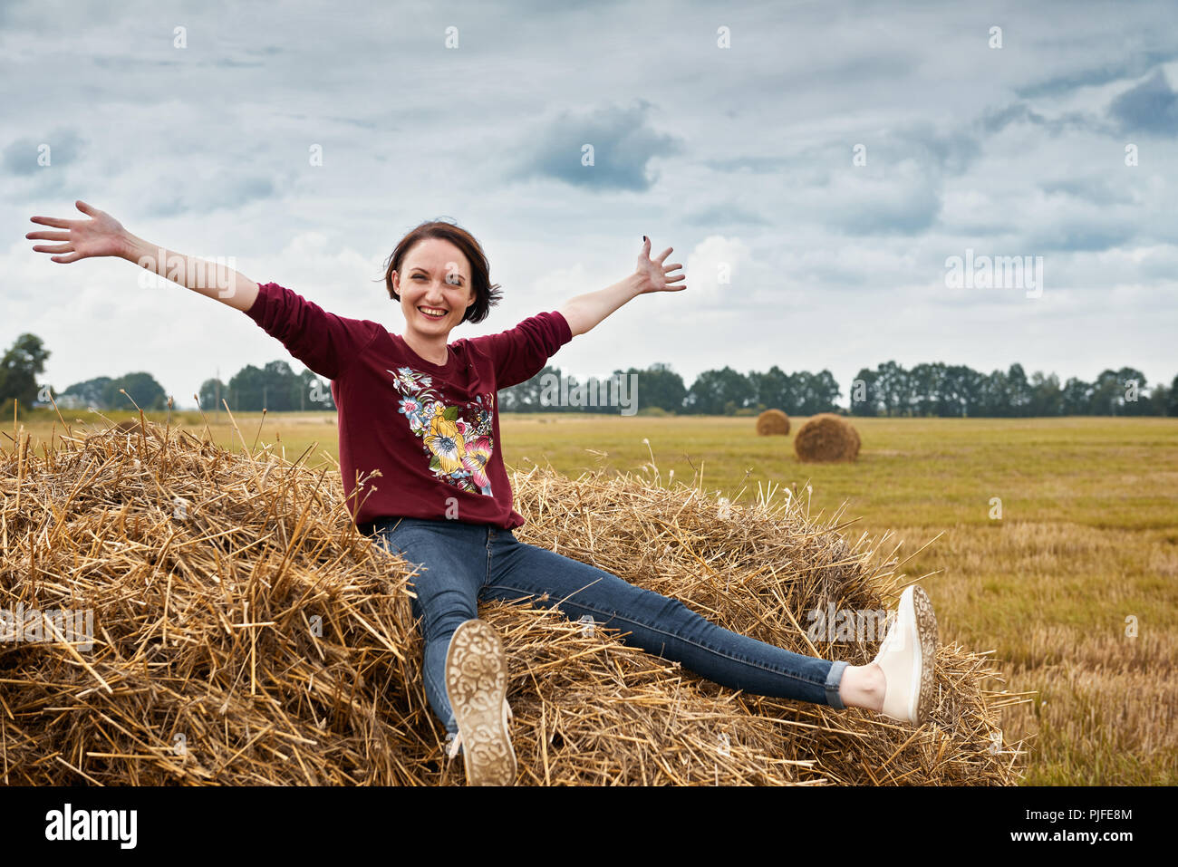 Girl sitting on hay stack hi-res stock photography and images - Alamy