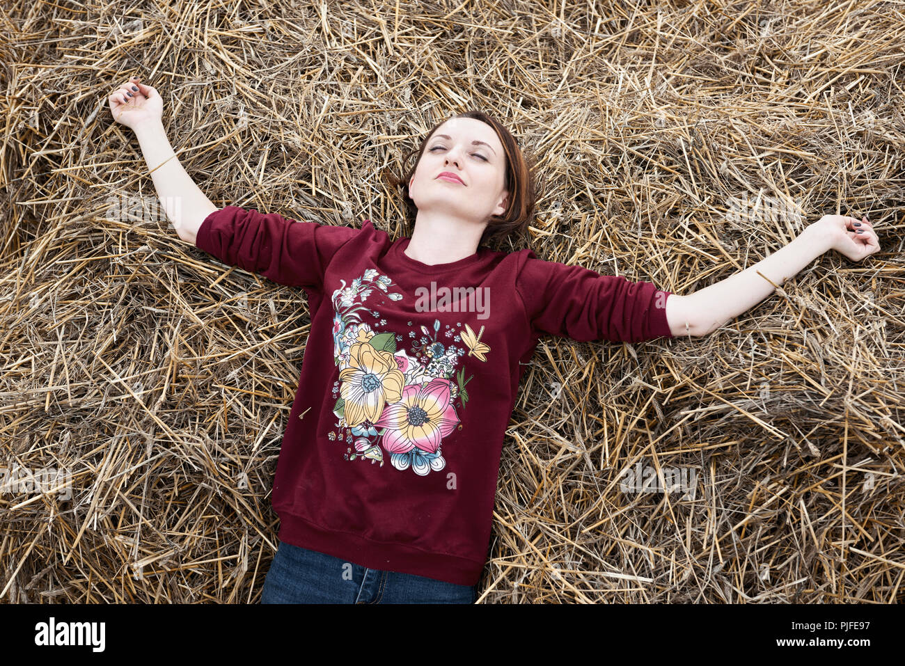 Girl lying on haystack hi-res stock photography and images - Alamy