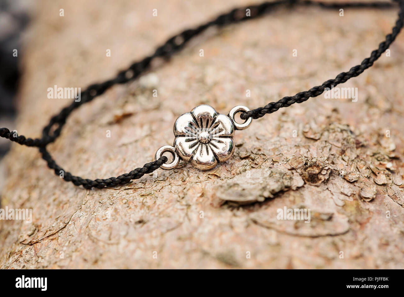 Tiny fashionable female bracelet on wooden background Stock Photo - Alamy