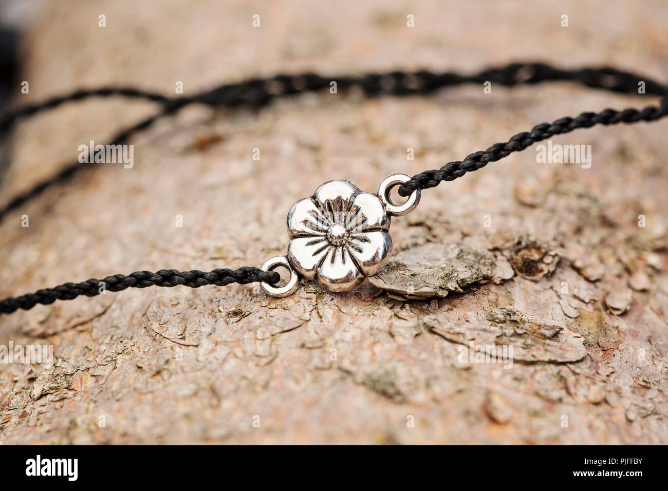 Tiny fashionable female bracelet on wooden background Stock Photo - Alamy