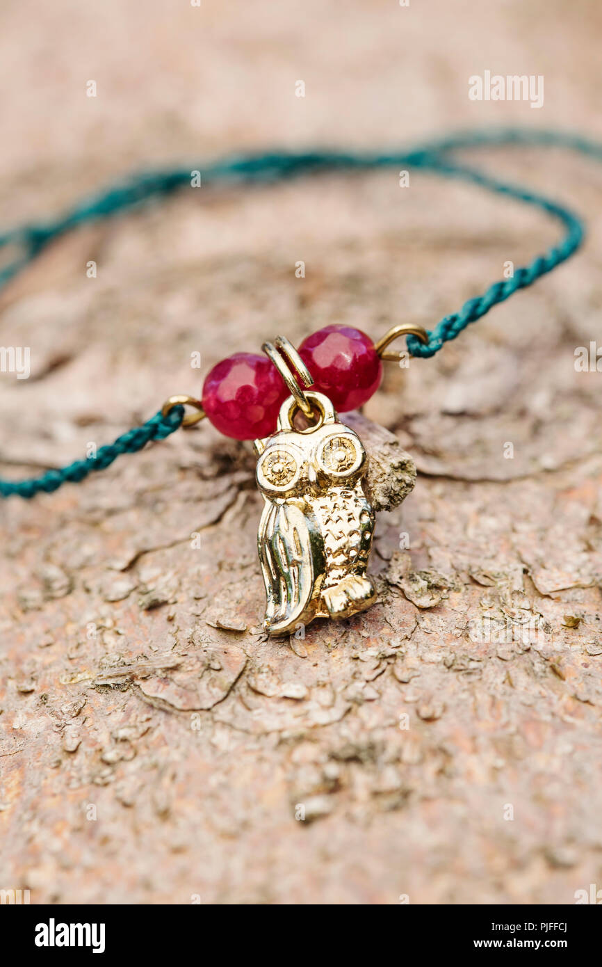 Tiny fashionable female bracelet on wooden background Stock Photo - Alamy