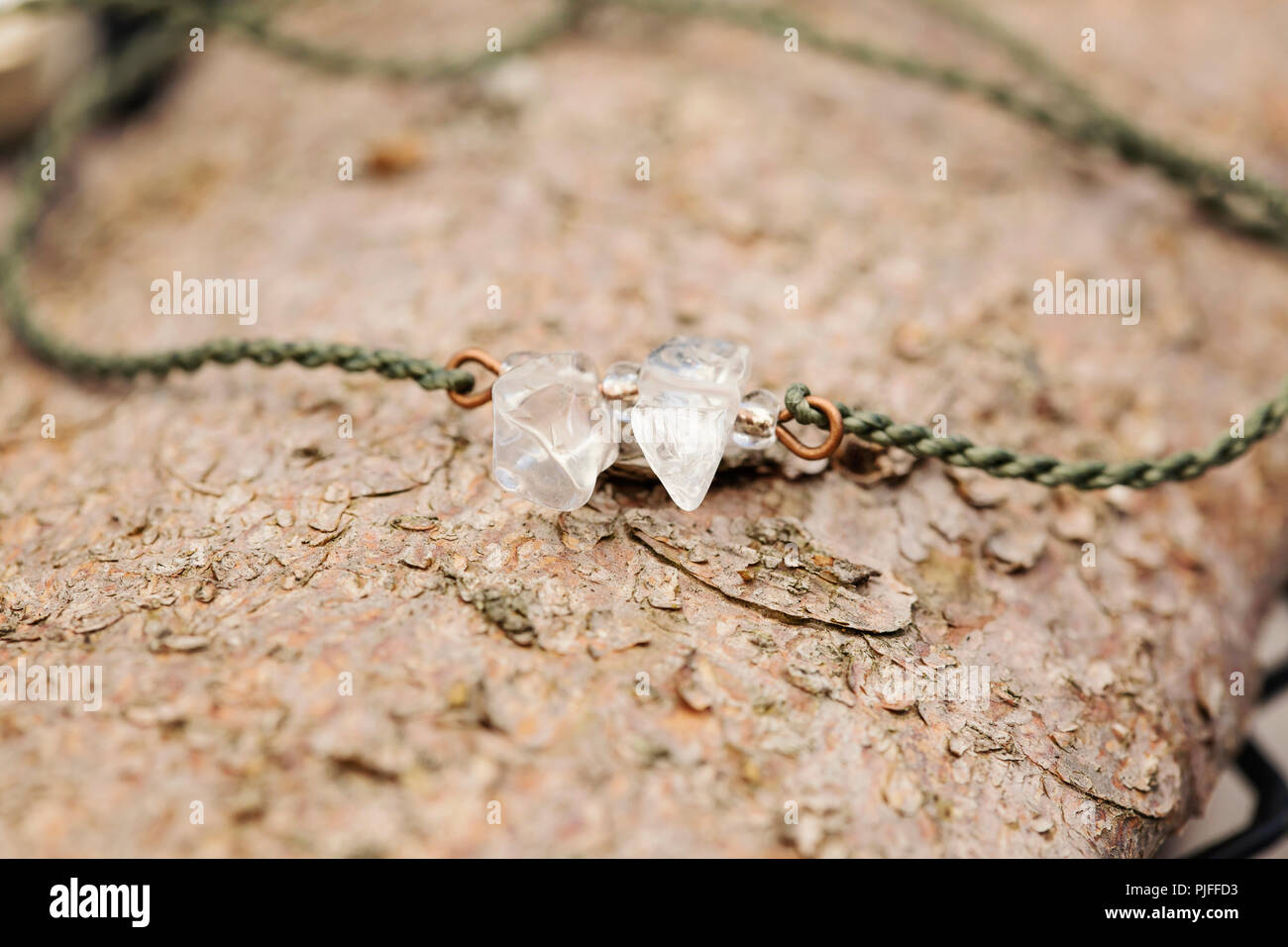 Tiny fashionable female bracelet on wooden background Stock Photo - Alamy