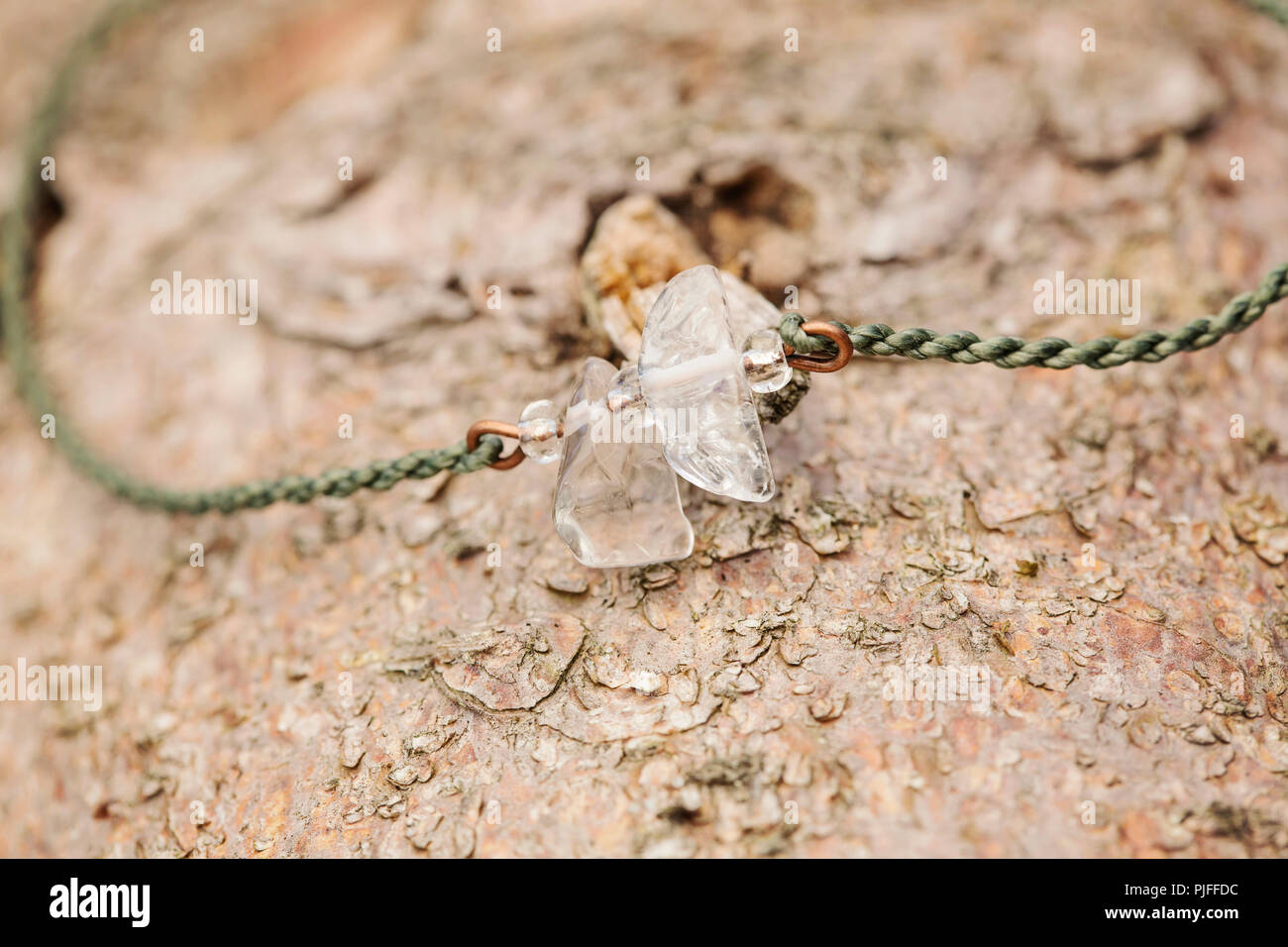 Tiny fashionable female bracelet on wooden background Stock Photo - Alamy