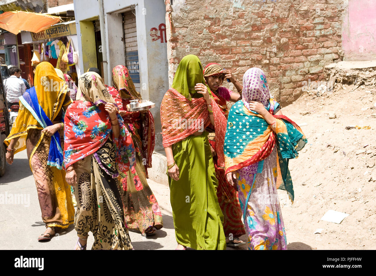 Traditional indian woman performing hindu rituals at Radha Kund and ...