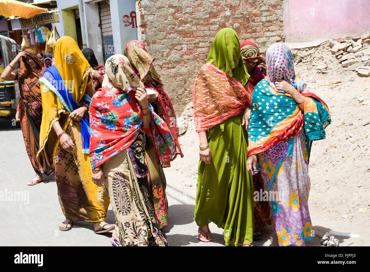 Traditional indian woman performing hindu rituals at Radha Kund and ...