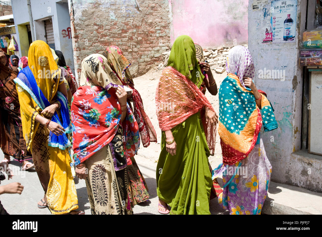 Traditional indian woman performing hindu rituals at Radha Kund and ...