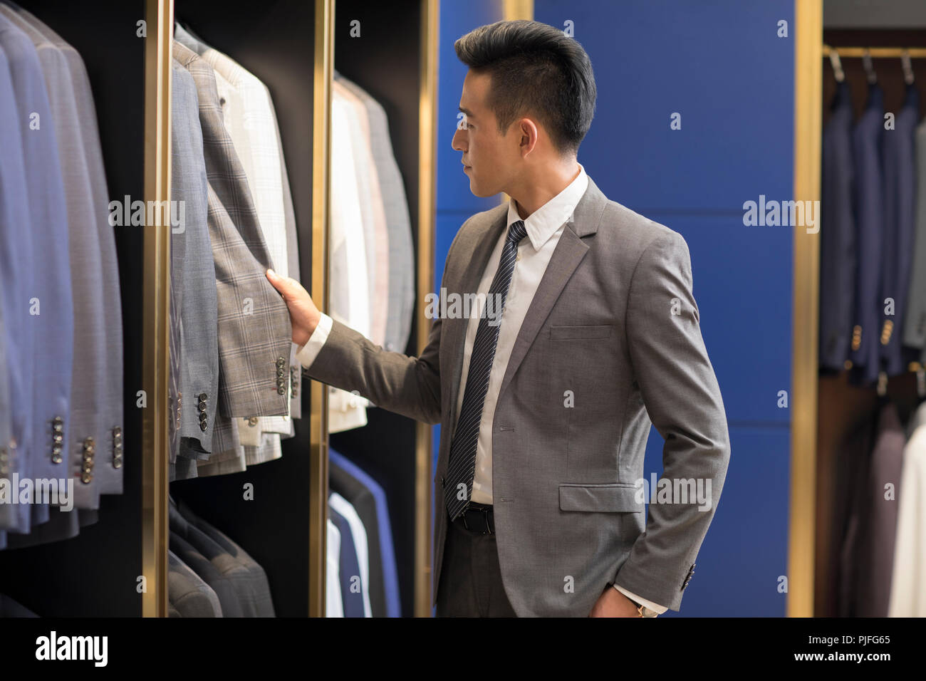 Businessman shopping in a men's wear store Stock Photo - Alamy