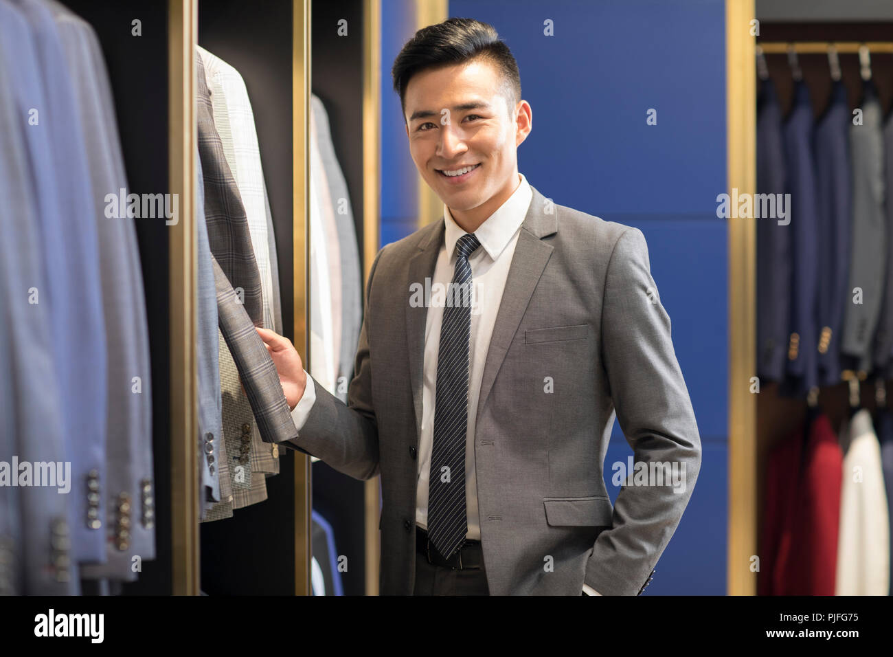 Businessman shopping in a men's wear store Stock Photo - Alamy