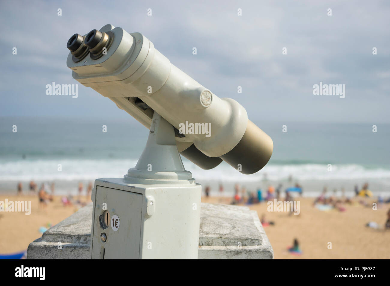 Coin operated binocular on the summer beach, tourist scene in Spain ...