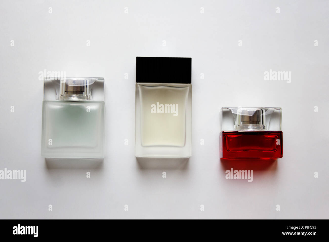 Three rectangular glass perfume bottles isolated on white background ...