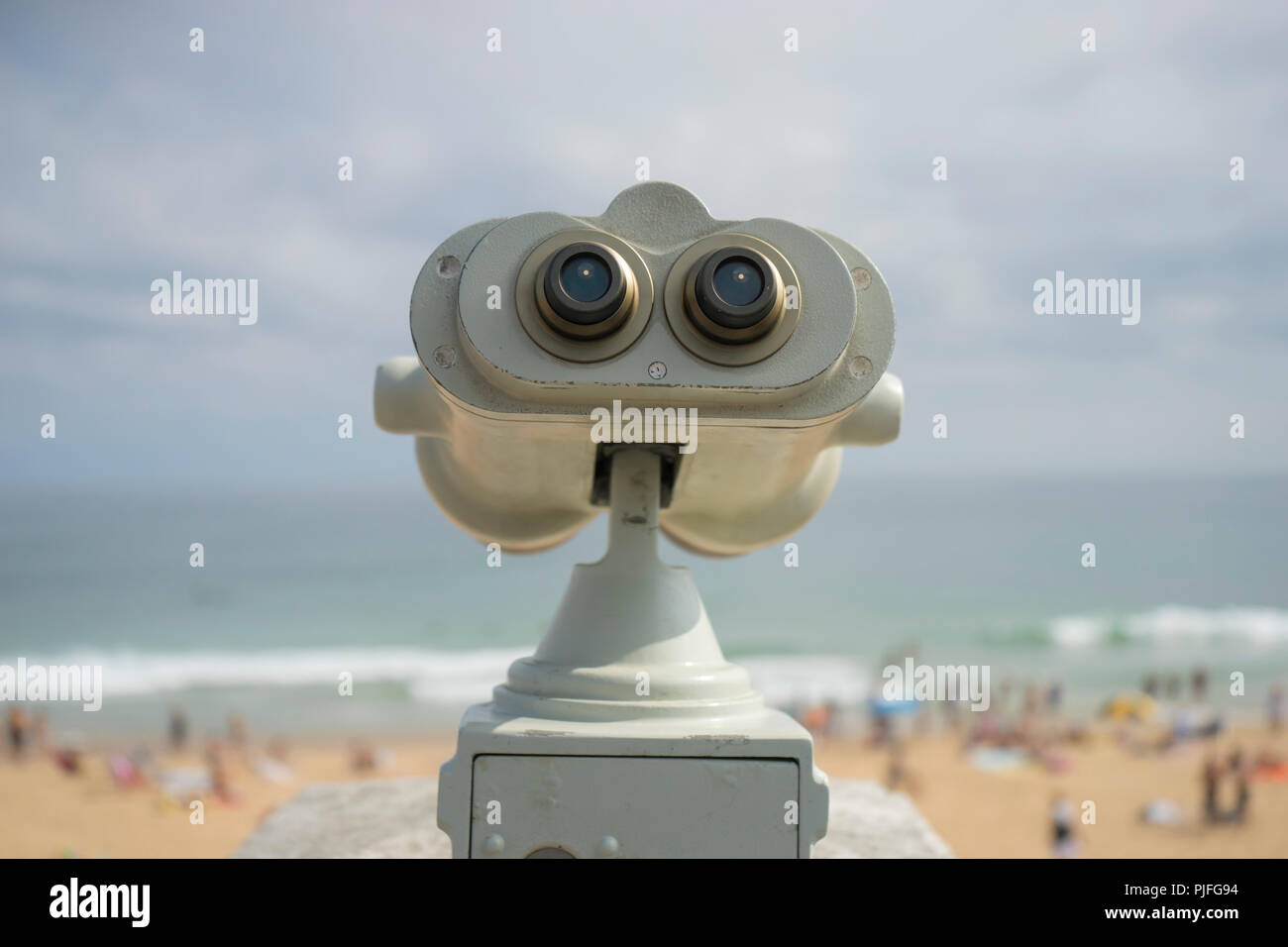 Coin operated binocular on the summer beach, tourist scene in Spain ...