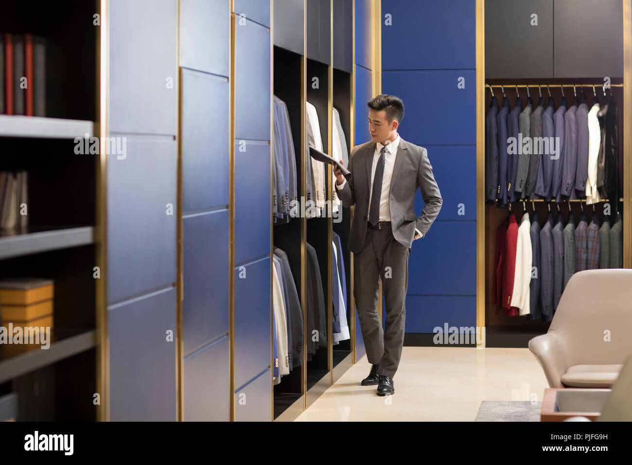 Businessman shopping in a men's wear store Stock Photo - Alamy