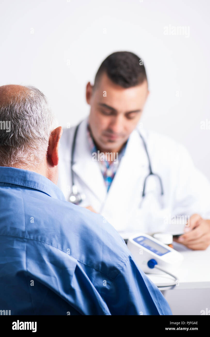 closeup of a senior caucasian patient man seen from behind and a ...