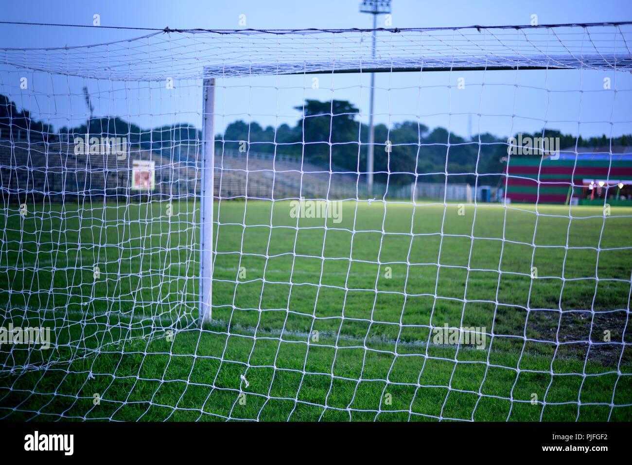 photograph is taken from behind the empty soccer goal Stock Photo - Alamy