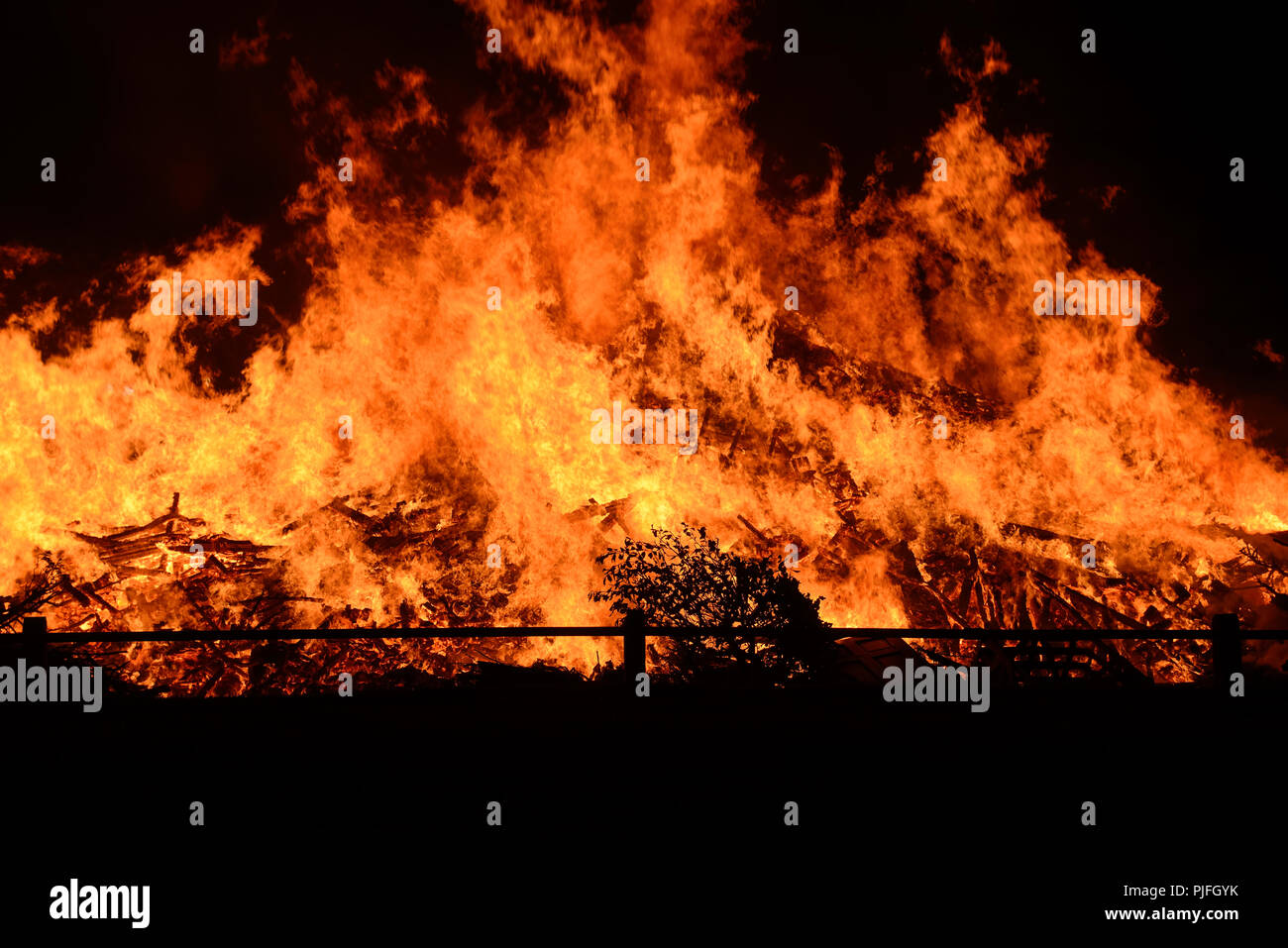 The swirling orange coloured flames of a large bonfire at night Stock ...