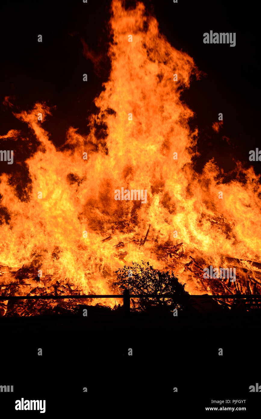 The swirling orange coloured flames of a large bonfire at night Stock ...
