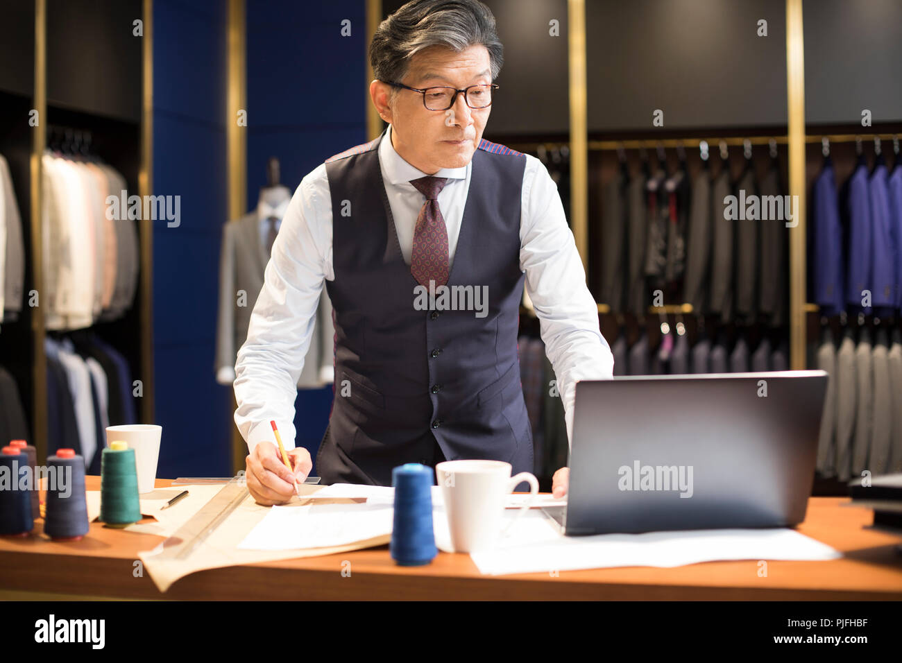 Confident fashion designer working Stock Photo - Alamy