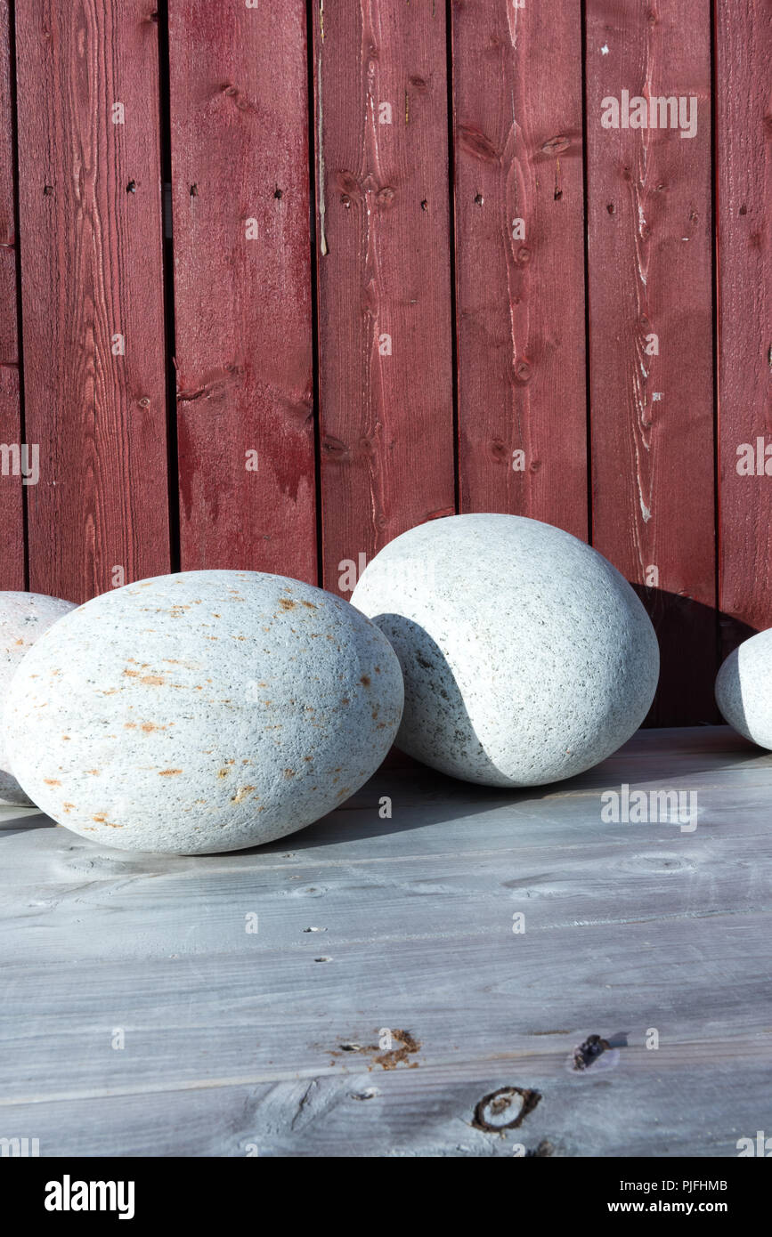Smooth Round Stones on Wooden Decking against Cladding Stock Photo - Alamy