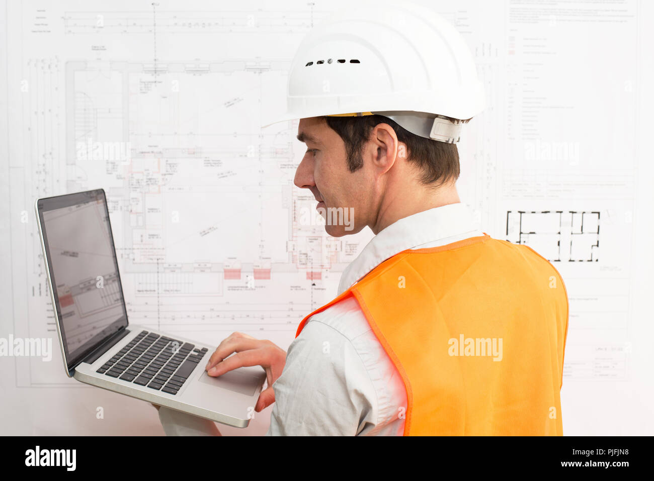 architect at his workplace with notebook - house building and ...