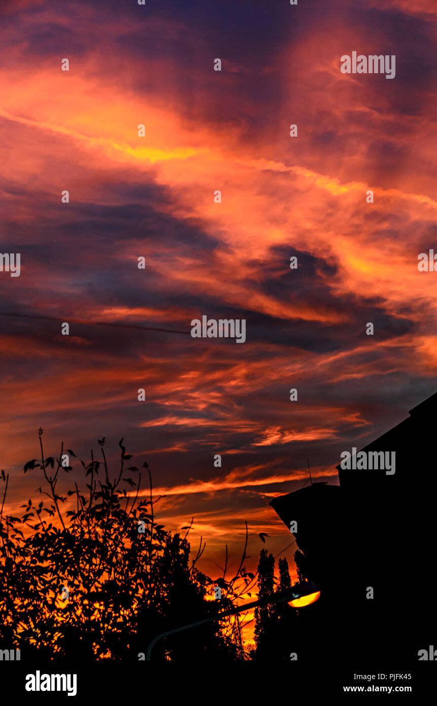Vivid colored mystic sky, dark silhouette, ray of lights Stock Photo ...