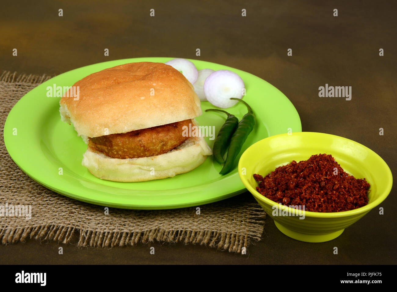 Vada Pav with onion slices green chili and garlic chutney, a popular ...